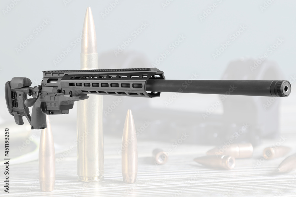 modern powerful sniper rifle, black. weapons next to bullets, casings ...