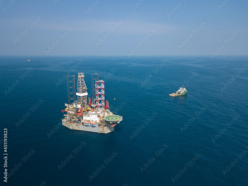 Offshore drilling rig (jack up rig) and tow vessels during the rig move ...