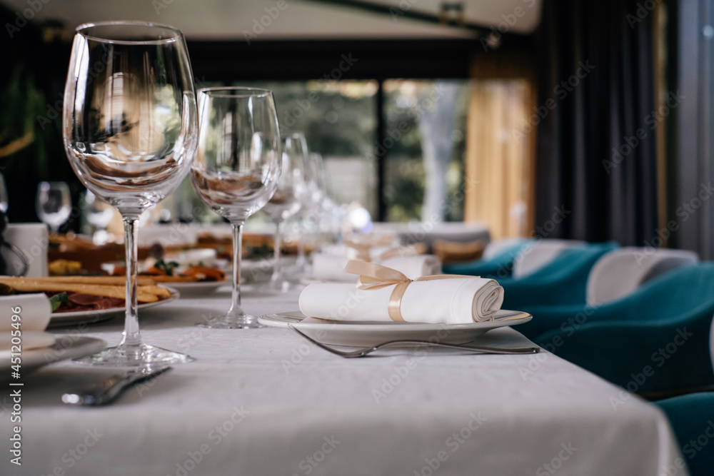 Glasses on restaurant table full of food by window Stock Photo | Adobe ...