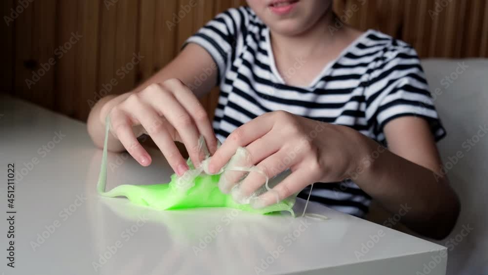 Playing with textured slime with bubbles, stretching the gooey ...