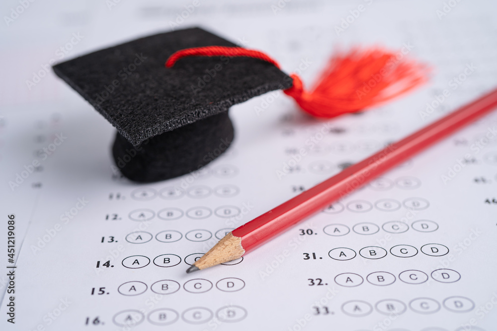 Graduation gap hat and pencil on answer sheet background, Education ...
