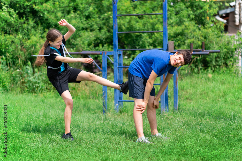 Teenage Boy And Girl Exercising Outdoors And Having Fun Sports Ground 4584
