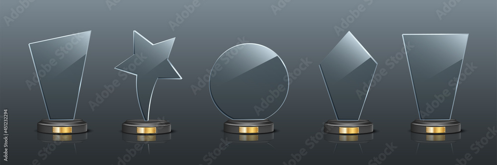 Award trophy set. Star and rectangle shaped glass prize statues on gray ...