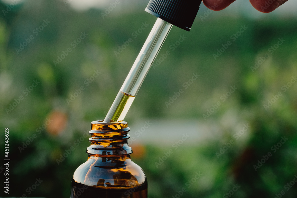 Pipette and bottle of essential oil. Eucalyptus essential oil dripping ...