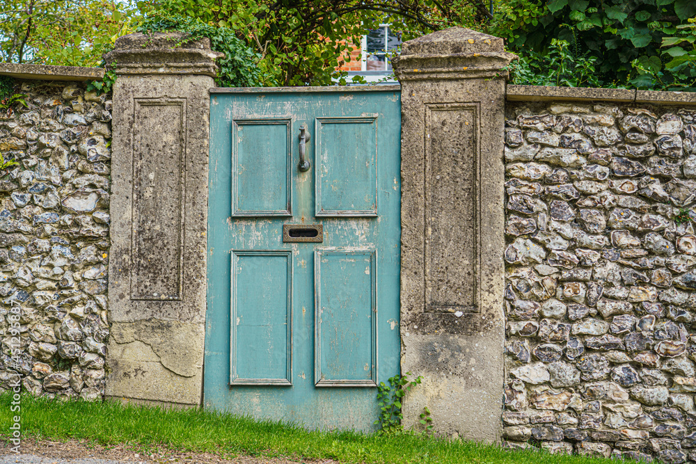a blue painted aged wooden door leading to the garden of the Manor Farm ...