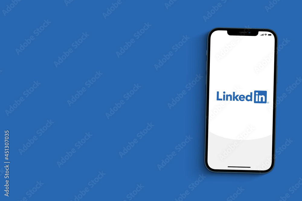 Linkedin app on smartphone screen on blue background. Social media. Top ...