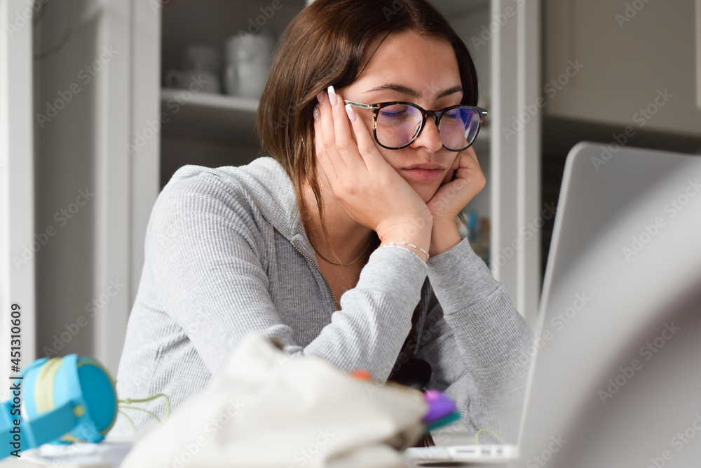 Young girl student falling asleep while studying in front of laptop ...