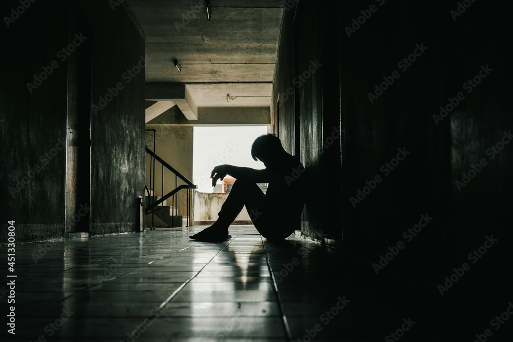 Dramatic, Silhouette of Sad Depressed man sitting head in hands on the ...