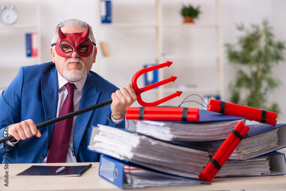 Old male devil employee with dynamite in the office Stock Photo | Adobe ...