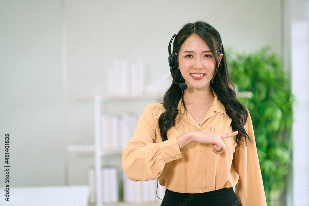 Asian female call center agent standing and use sign language with ...