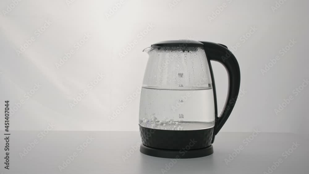 home technology, electric transparent kettle heats up water, drops of ...
