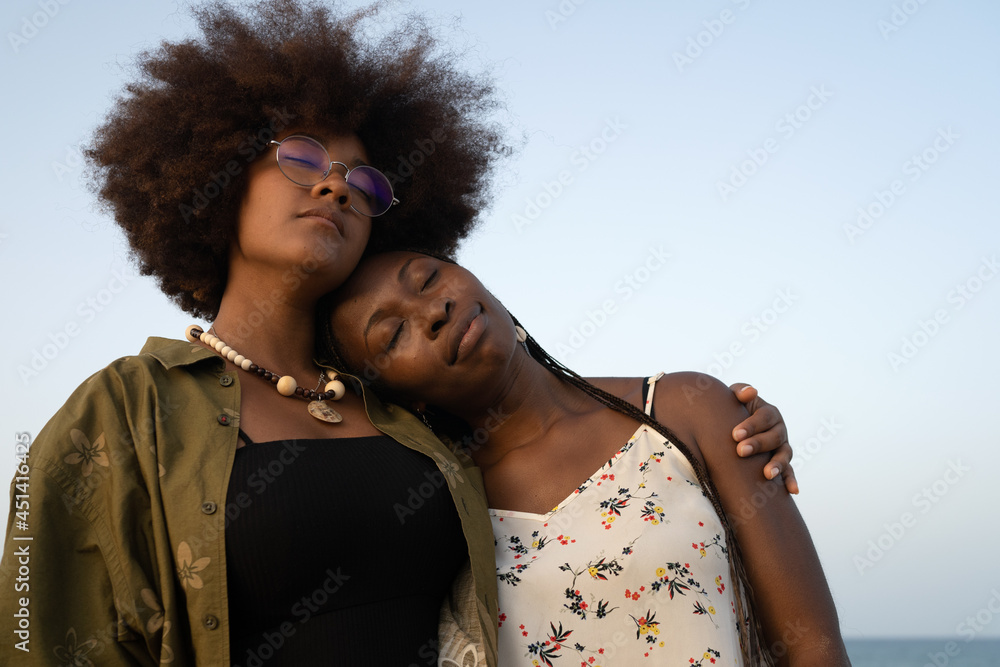 Black women hugging on beach Stock Photo | Adobe Stock