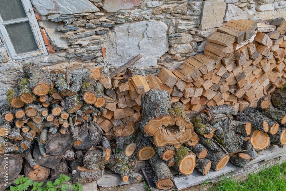 Stacked firewood wood lumber timber stack logs and trunks pile by a ...
