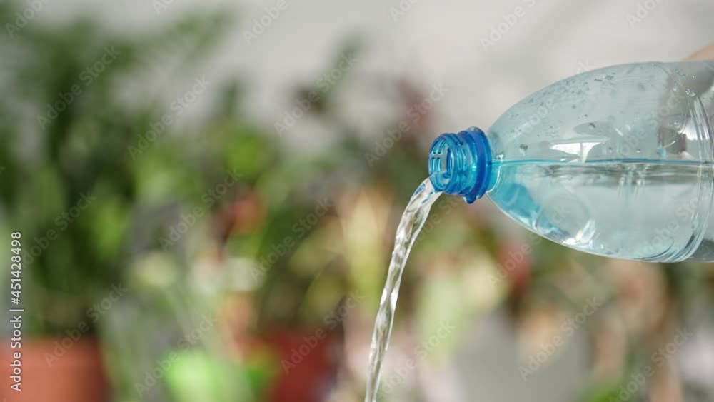 water balance, drinking mineral water pouring from a plastic with a ...