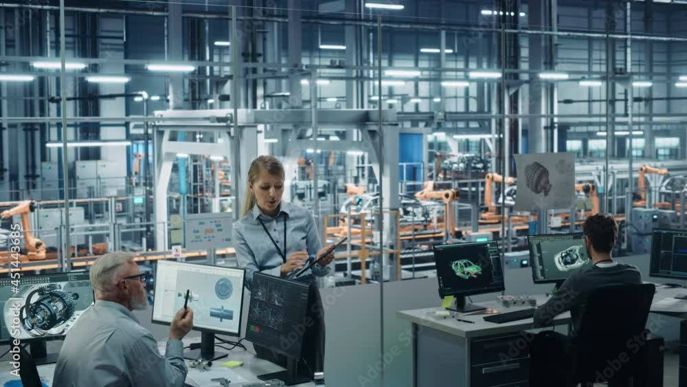 Car Factory: Diverse Team of Automotive Engineers Working, Using Computers to Design Advanced ...