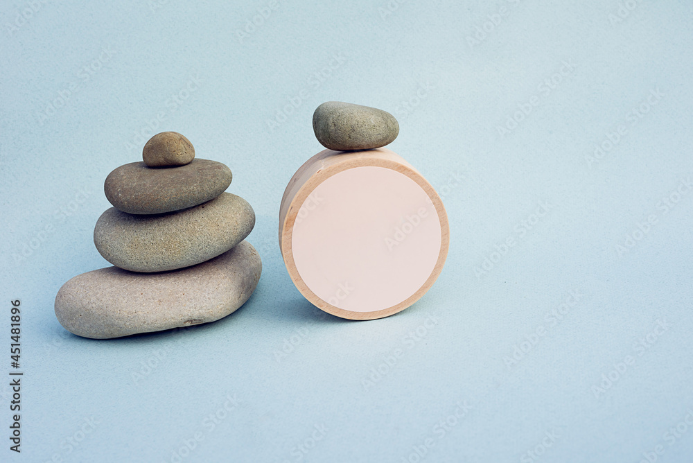 Stack of pebbles and a round bamboo box with blanck name label and a ...