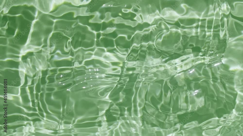Water splash green colored. Pure water with reflections sunlight in ...