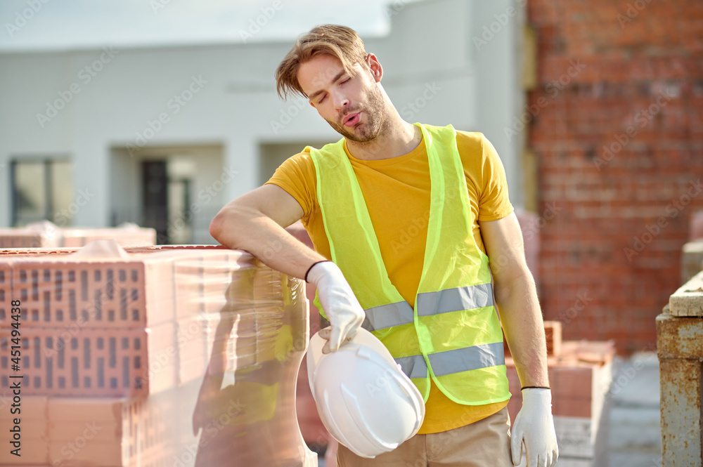 Exhausted young worker taking a break from work Stock Photo | Adobe Stock