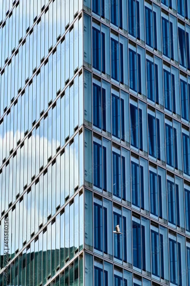 Sharp corner of modern building with mirrored glass facade, abstract ...