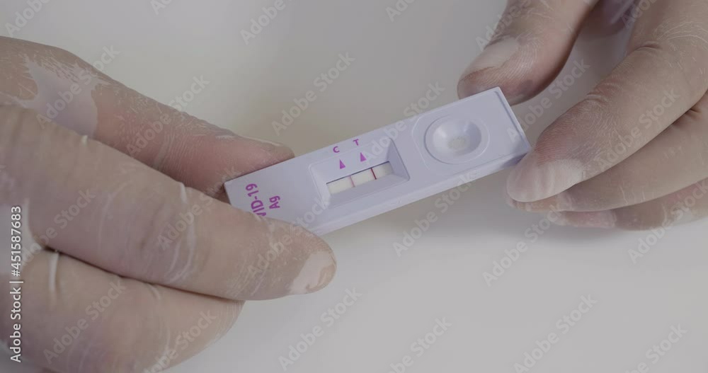 Closeup of a doctor's hand showing a covid-19 antigen pcr express test ...
