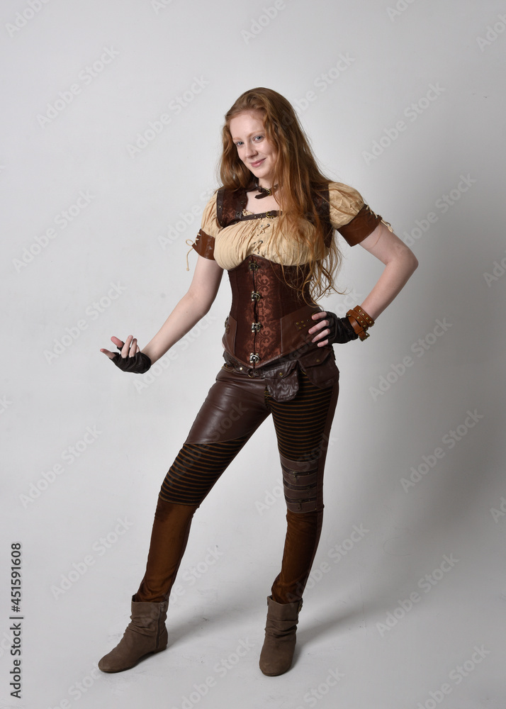 Full length portrait of beautiful young woman with long red hair ...