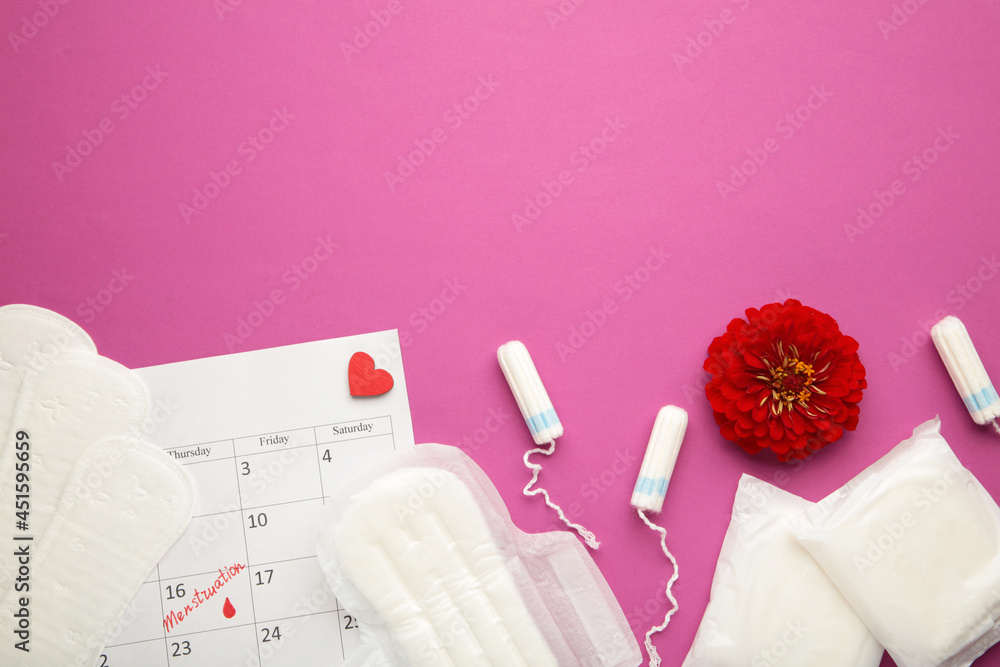 Menstruation calendar with cotton tampons and pads with flower on pink ...