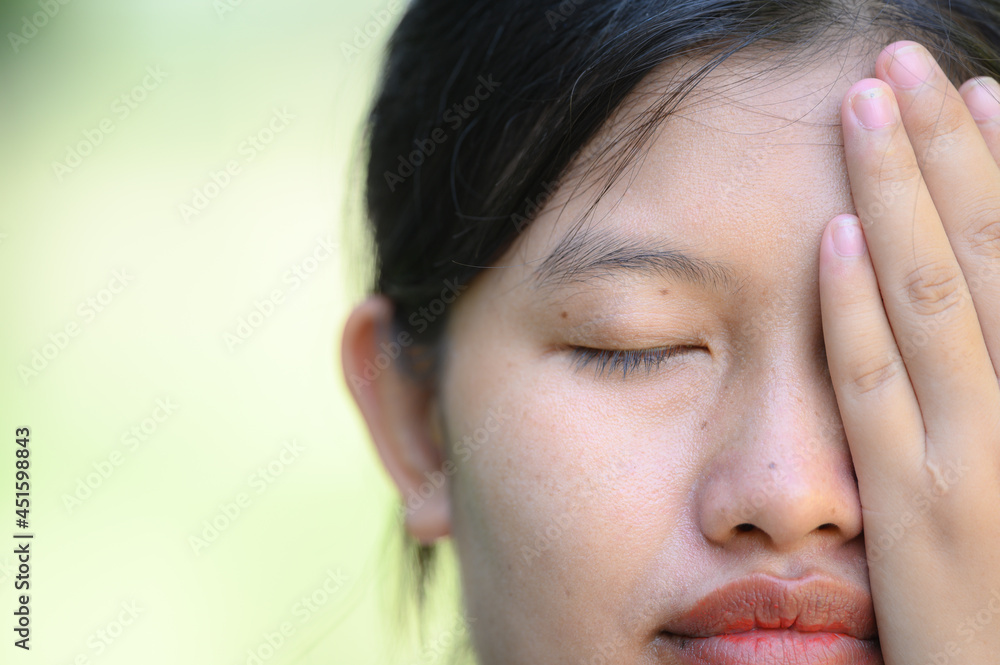 The face of an Asian woman has one hand covering her face.face without ...