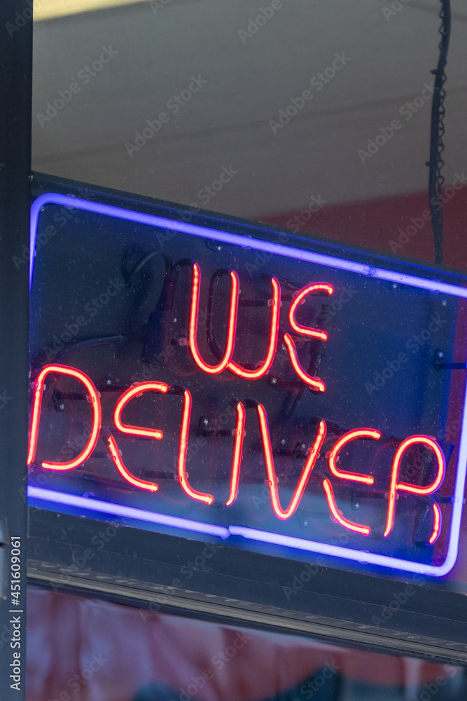 neon sign in restaurant window displays we deliver Stock Photo | Adobe ...