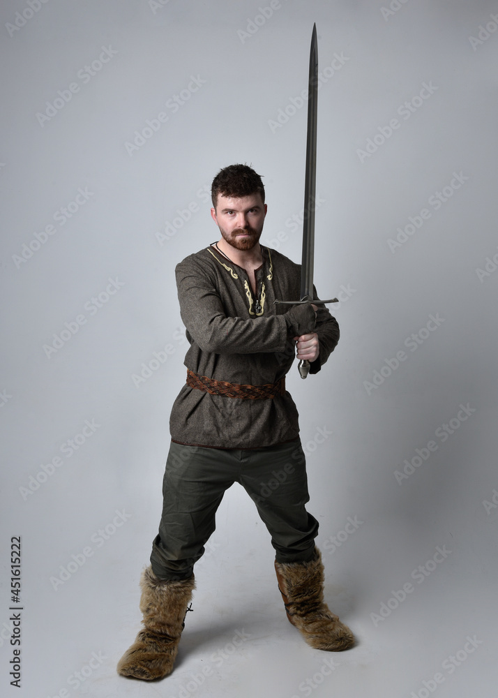 Full length portrait of young handsome man wearing medieval Celtic ...