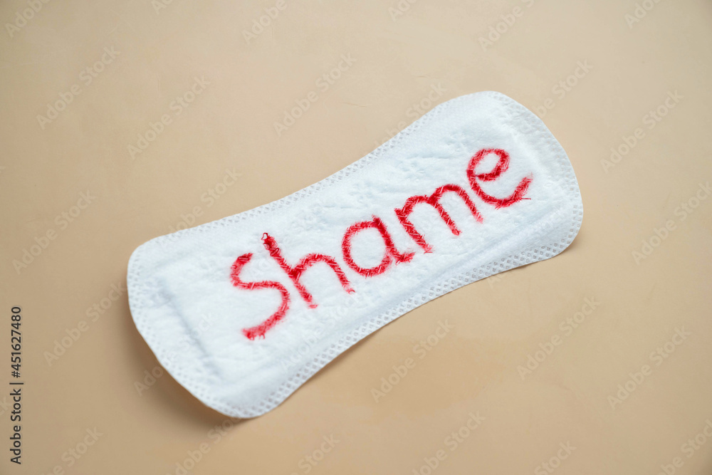Woman's sanitary pad with word shame. Abstract social concept of ...