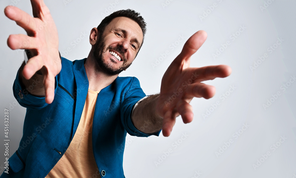 Portrait of friendly smiling adult man in casual blue jacket and yellow ...