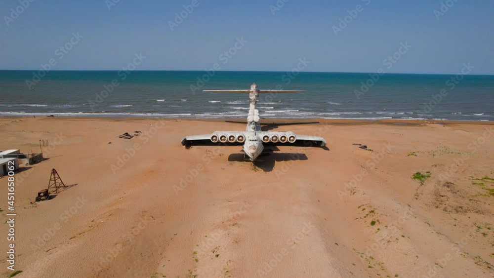 Old plane on beach. Action. Military plane landed on coast of sea many ...