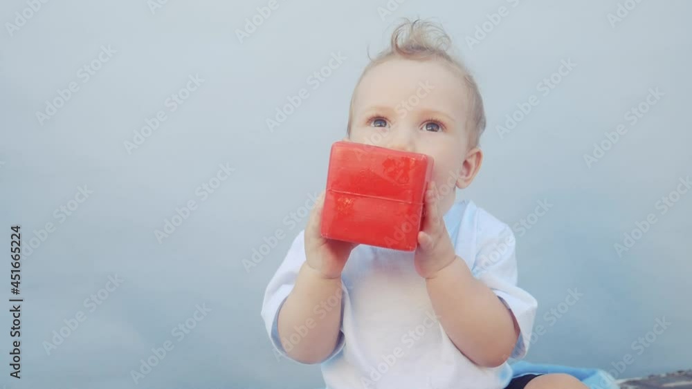 baby drooling bubbles on the lips a toddler play with a cube at home ...