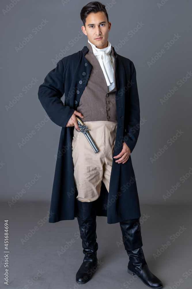 A Regency gentleman holding a flintlock pistol against a studio ...
