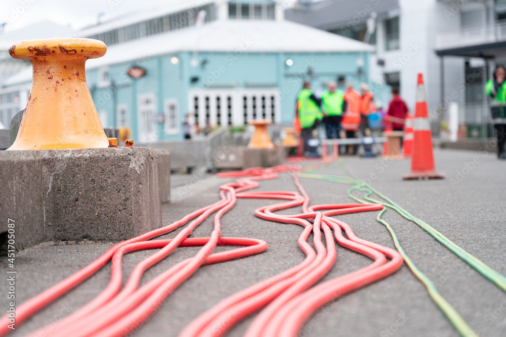 Orange and yellow and green polyethylene piping laid out along the ...