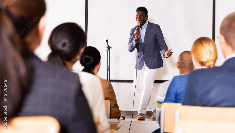 Excited african american preacher giving motivational speech to ...