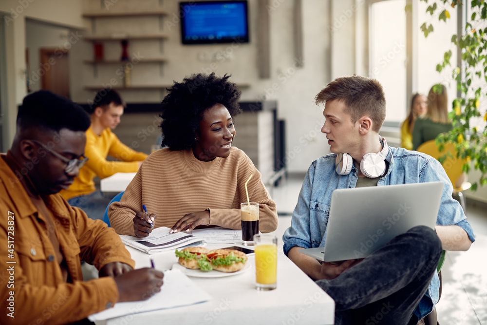 Happy multi-ethnic group of students study together on lunch break at ...
