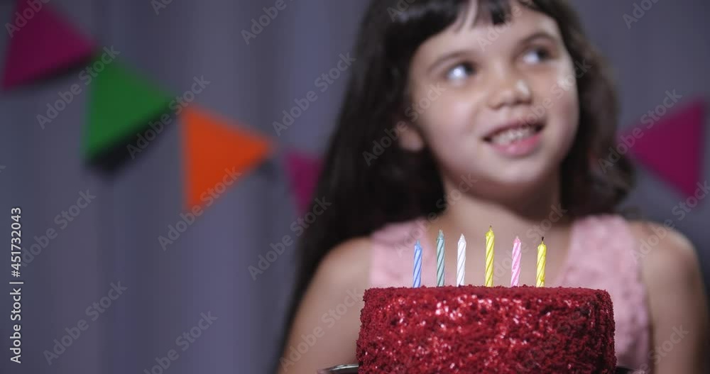 Close-up unfocused portrait of a six years old girl sitting near a ...