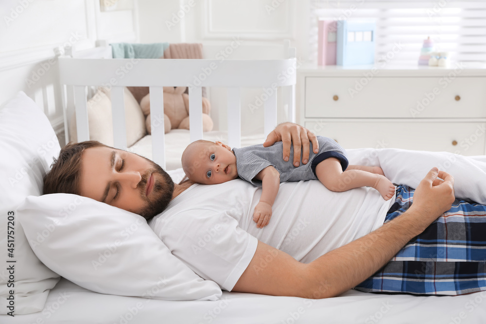 Tired young father sleeping with his baby in bed at home Stock Photo ...