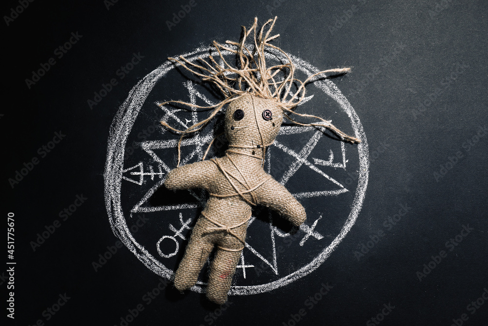 Female voodoo doll and runes on black background, top view Stock Photo ...