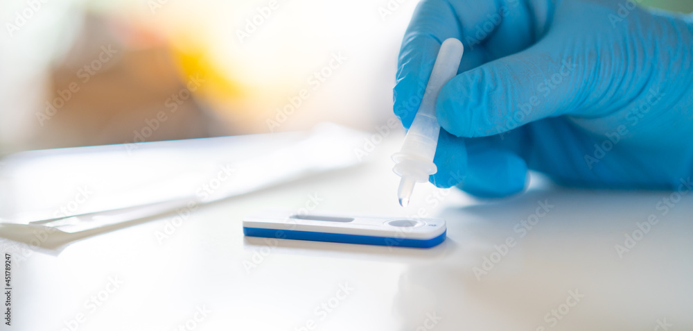 Man using a rapid antigen test kit. Rapid antigen testing is a ...