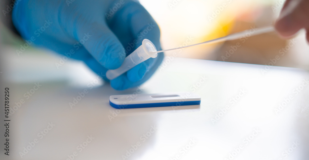 Man using a rapid antigen test kit. Rapid antigen testing is a ...