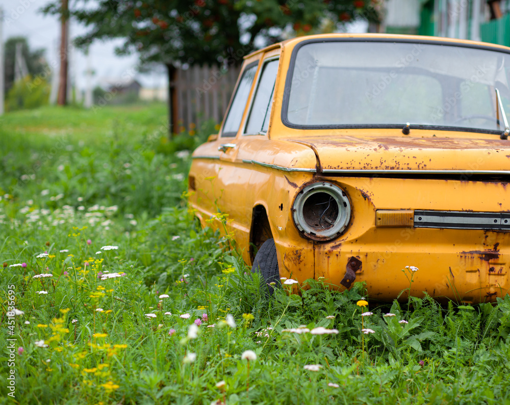 Old yellow wrecked car in vintage style. Abandoned rusty yellow car ...