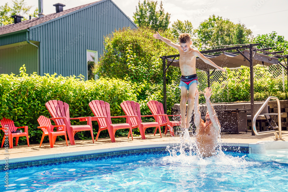 Father and son having fun in swimming pool Stock Photo | Adobe Stock