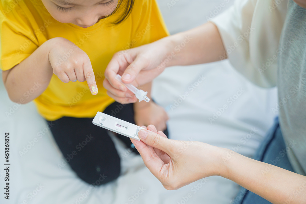 Adorable Asian girl kid pay attention with swab test process by her ...