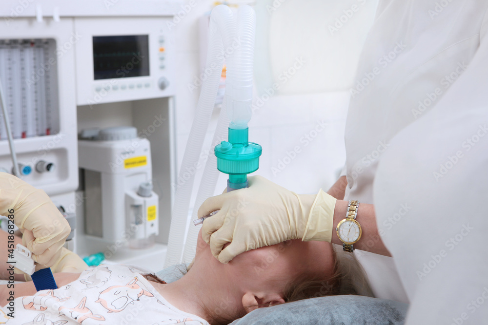 Intubation of the trachea. The child is connected to ventilator ...