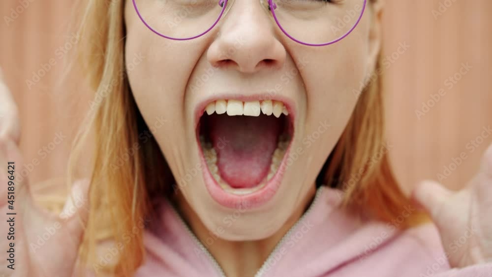 Close-up portrait of stressed woman blonde screaming expressing extreme ...