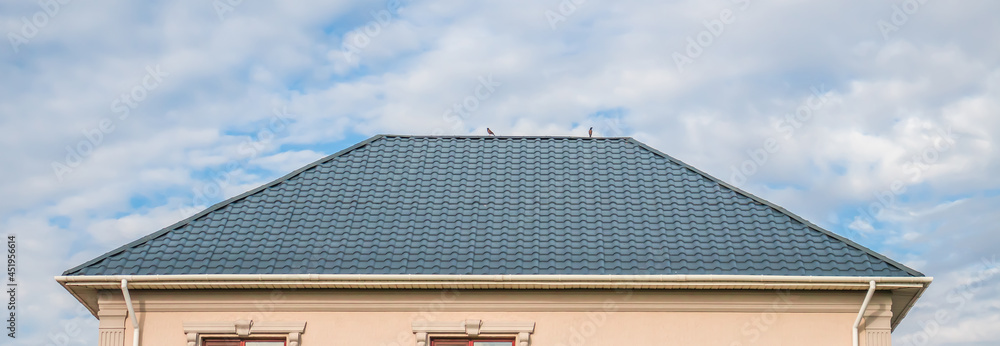 The roof is made of metal. Metal roofing sheets. Modern types of ...