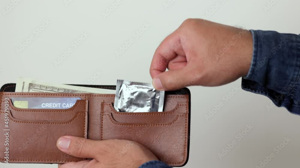The Young Man Took Out A Condom From His Wallet Ready To Use Anytime