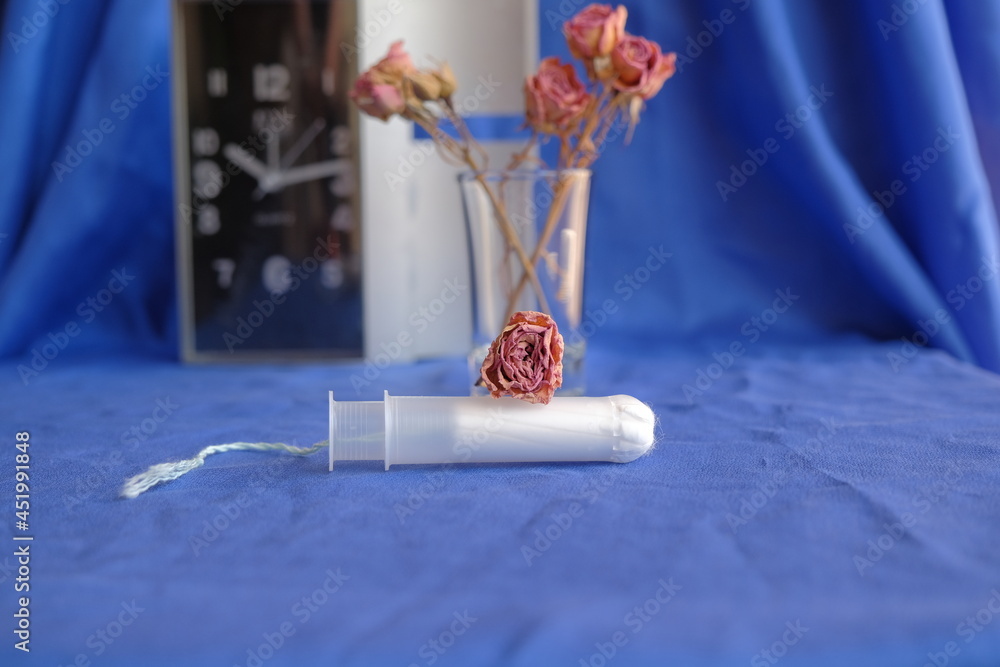 menopause concept. dried red rose lies on a woman tampon. dried rose ...